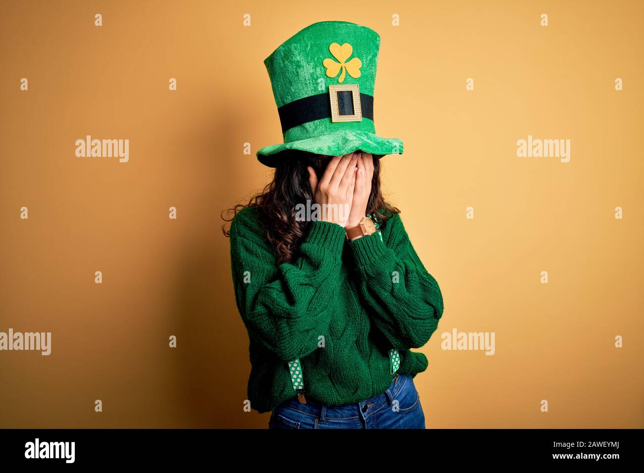 Beautiful curly hair woman wearing green hat with clover celebrating ...