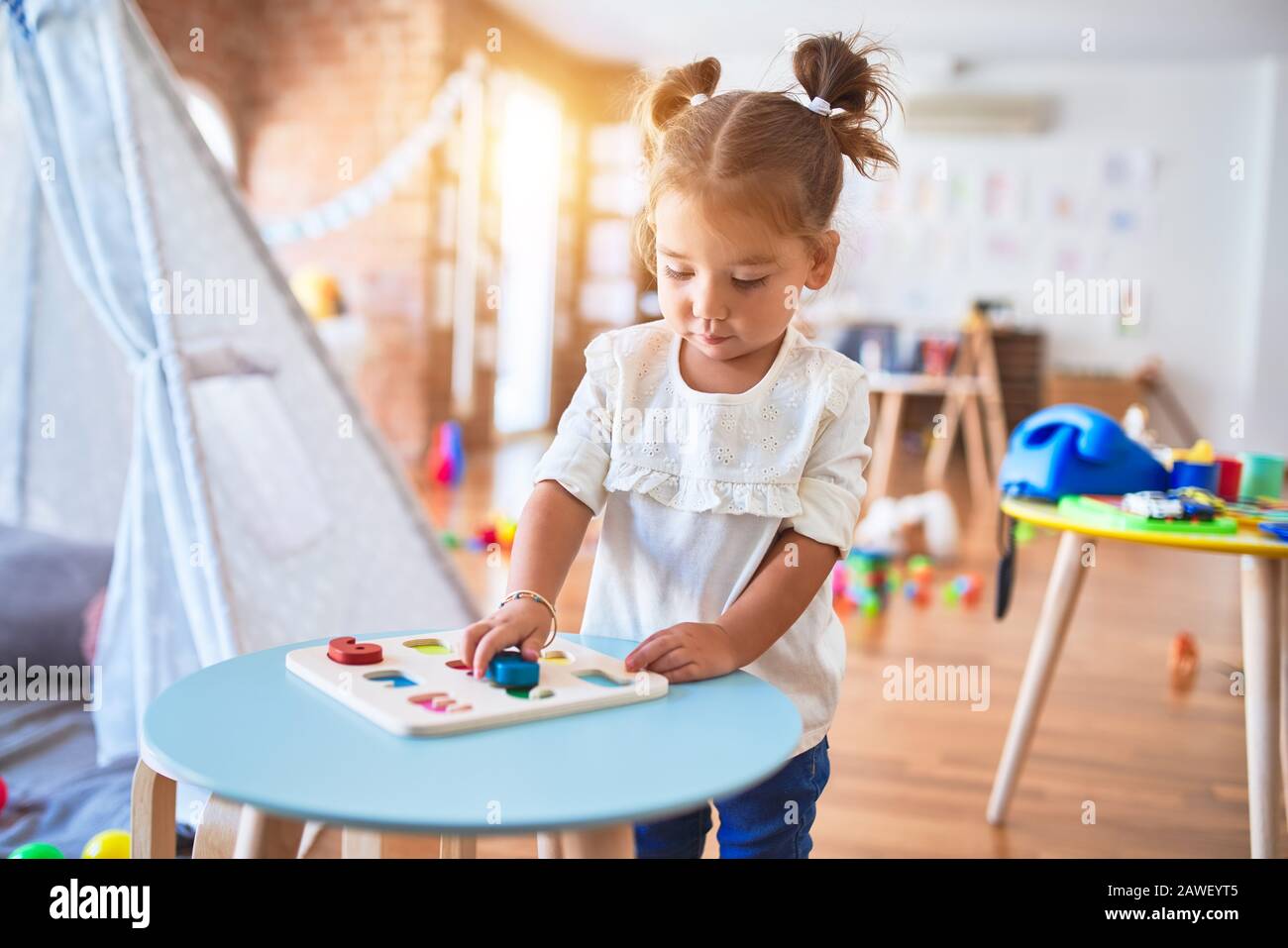 Young beautiful toddler learning mathematics playing with maths game at ...