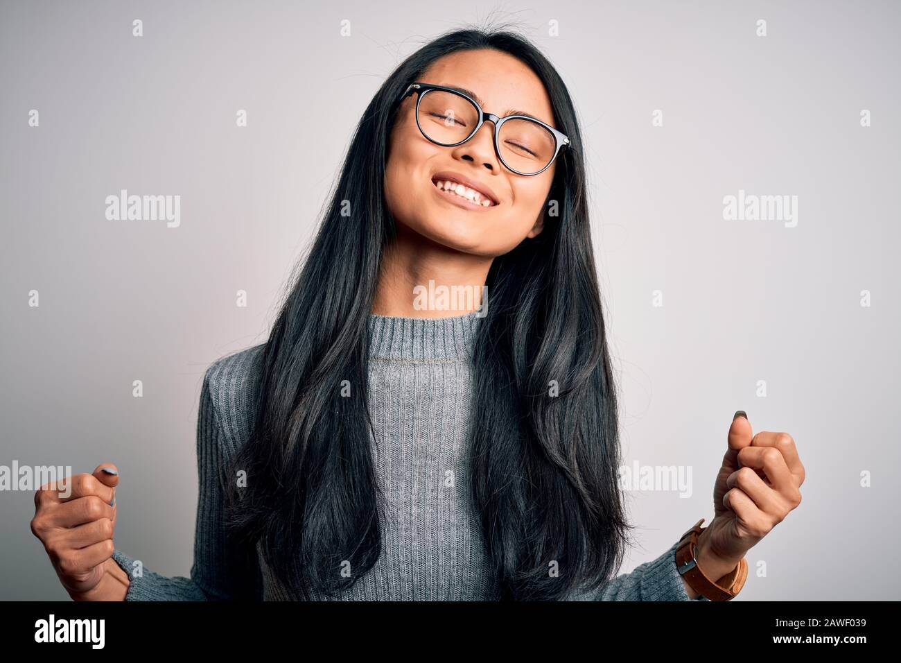 Young beautiful chinese woman wearing glasses and sweater over isolated ...