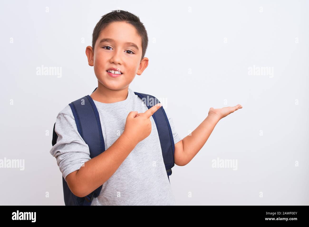 Beautiful student kid boy wearing backpack standing over isolated white ...