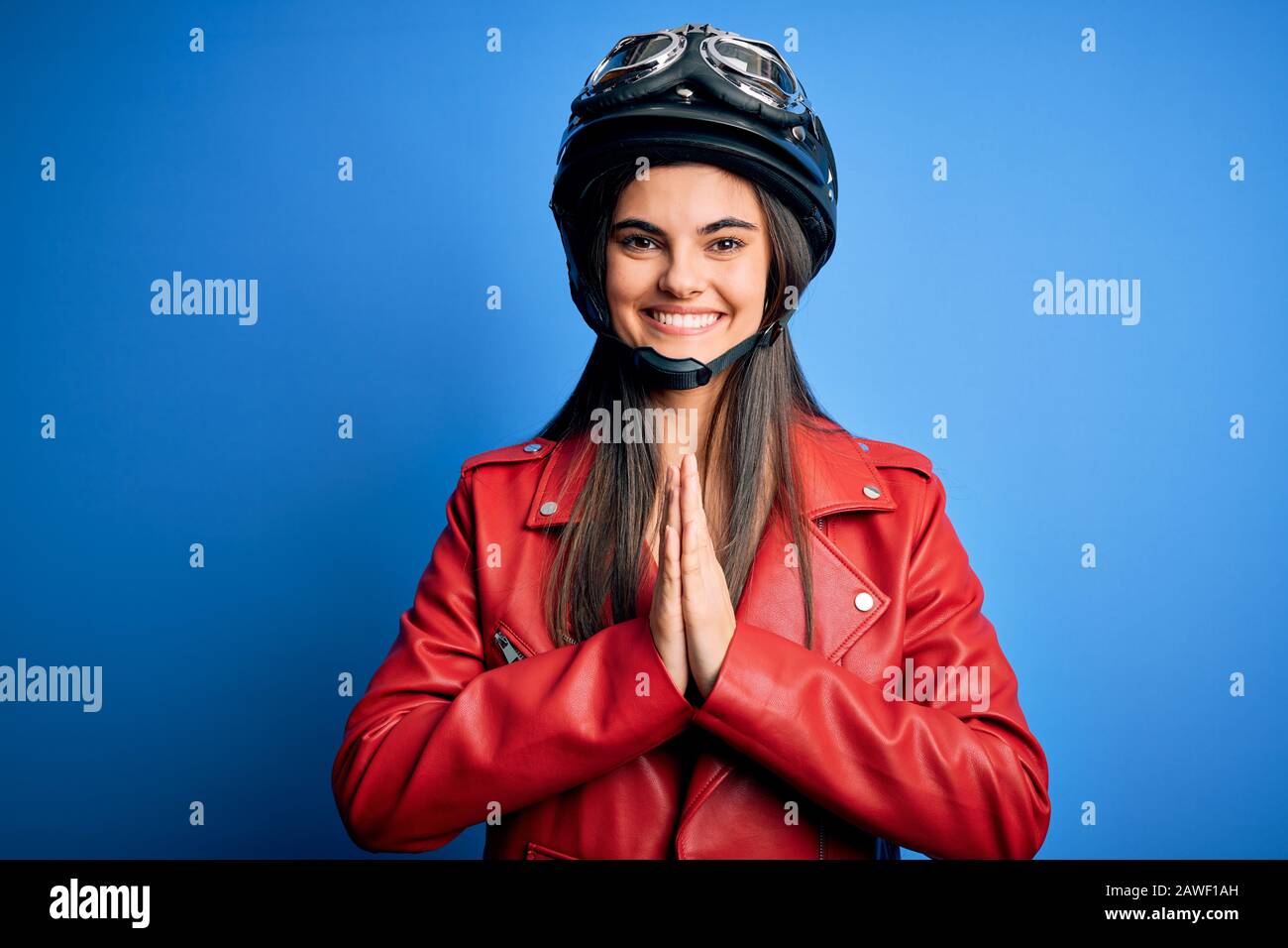 Young beautiful brunette motorcycliste woman wearing motorcycle helmet ...