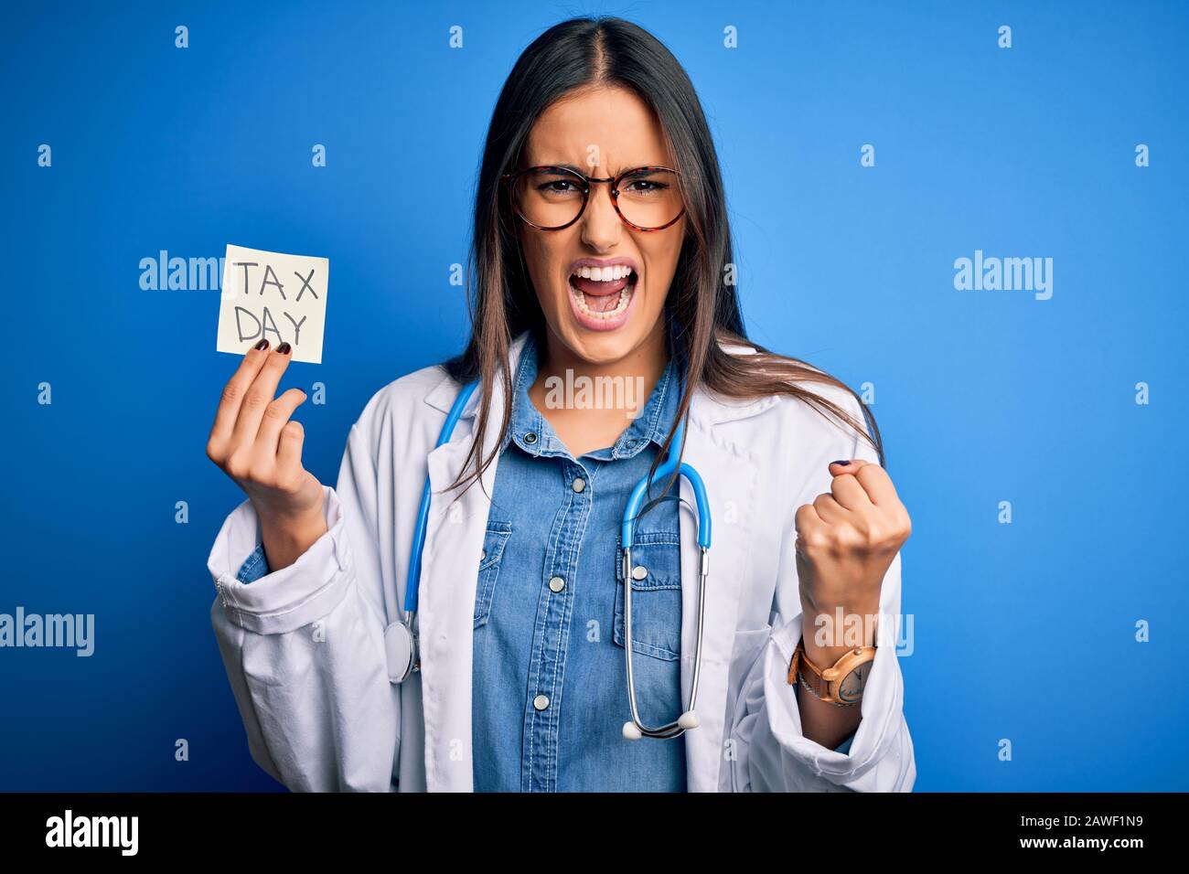 Young doctor woman wearing stethoscope holding paper with tax day ...