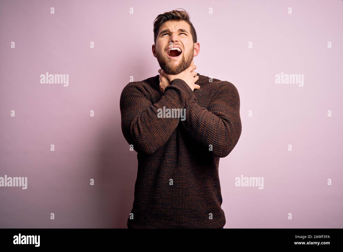 Young blond man with beard and blue eyes wearing casual sweater over ...