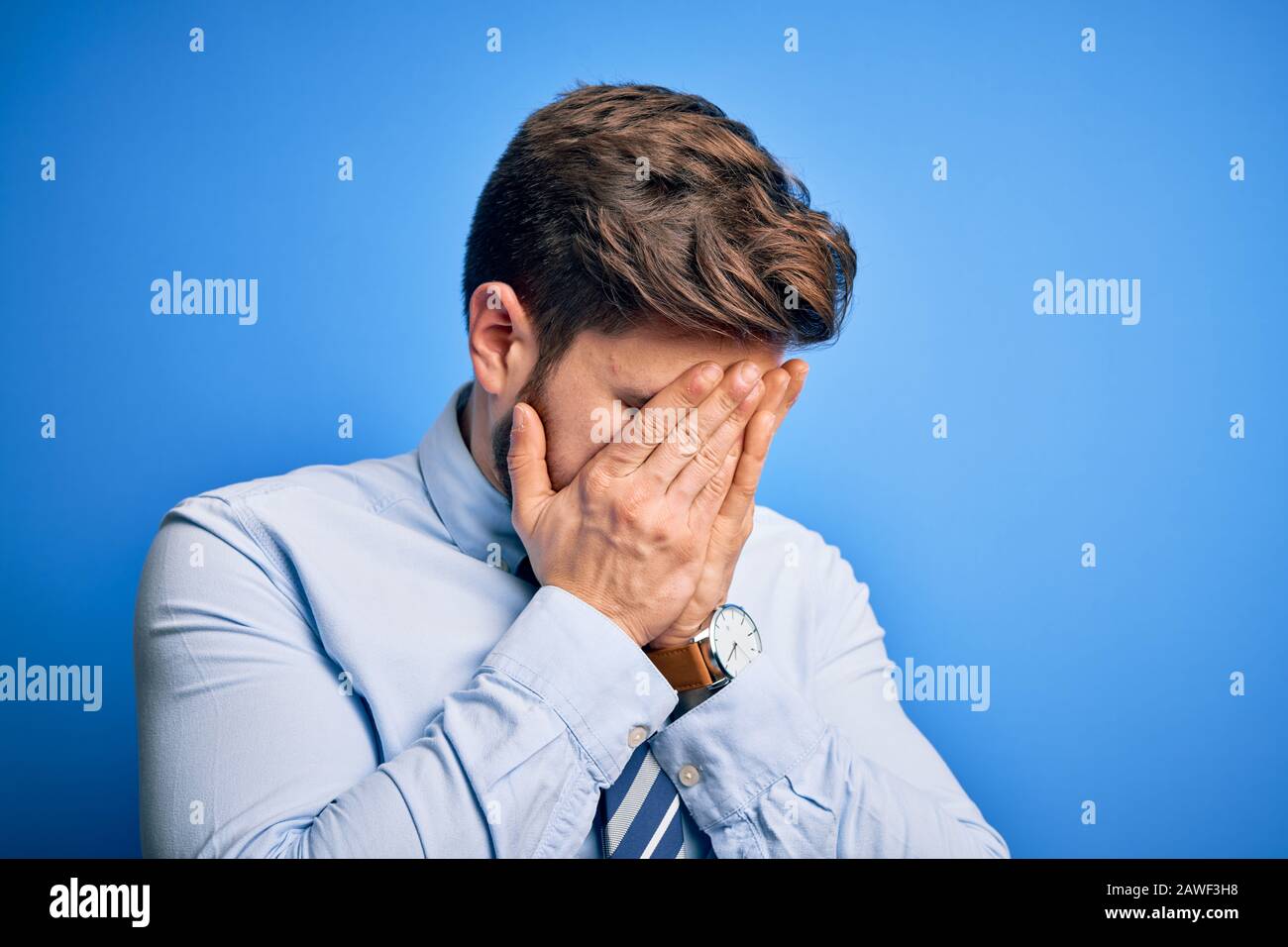 Young blond businessman with beard and blue eyes wearing elegant shirt ...