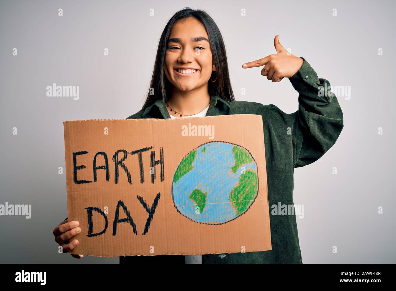 Young beautiful asian woman holding banner asking for earth and ...