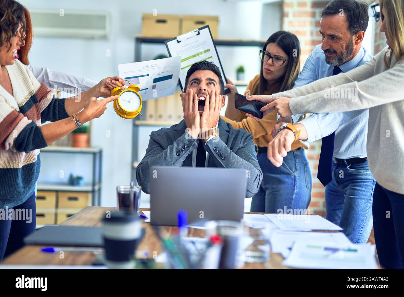 Group of business workers working together. Partners stressing one of ...