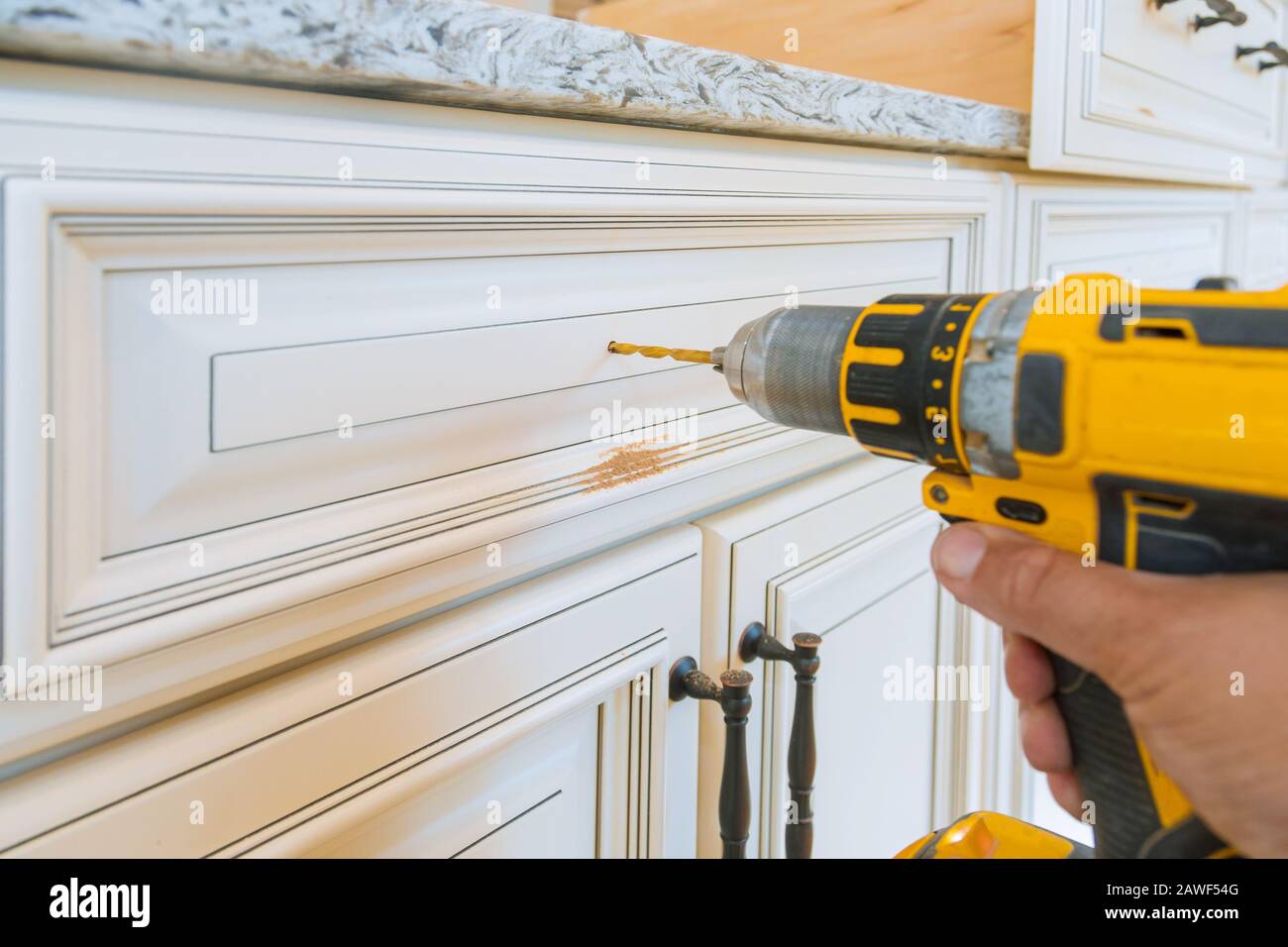 Handle installation drawers in custom kitchen cabinets Stock Photo - Alamy