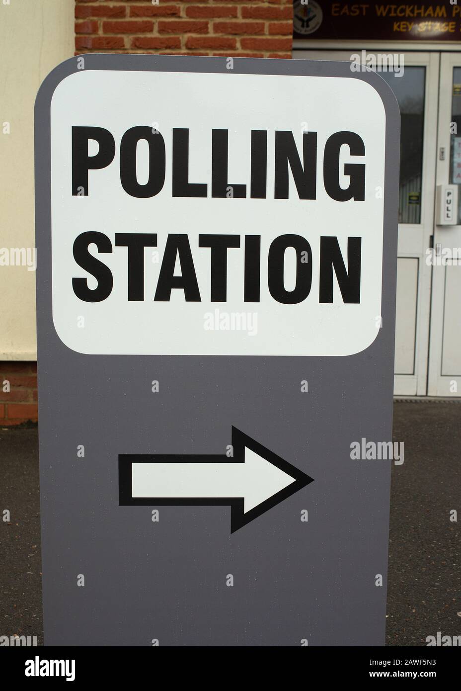 Large free standing POLLING STATION sign in a wet school playground ...