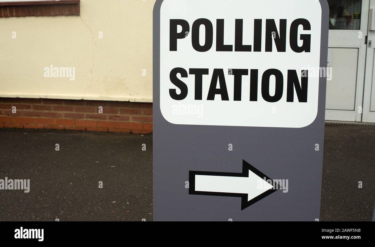 Large free standing POLLING STATION sign in a wet school playground ...