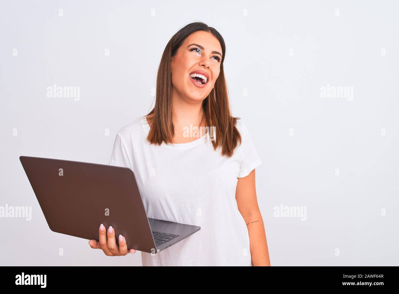 Beautiful young woman working using computer laptop over white ...
