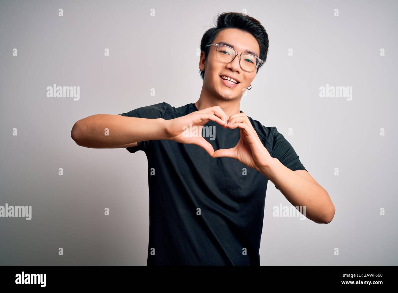 Young handsome chinese man wearing black t-shirt and glasses over white background smiling in ...