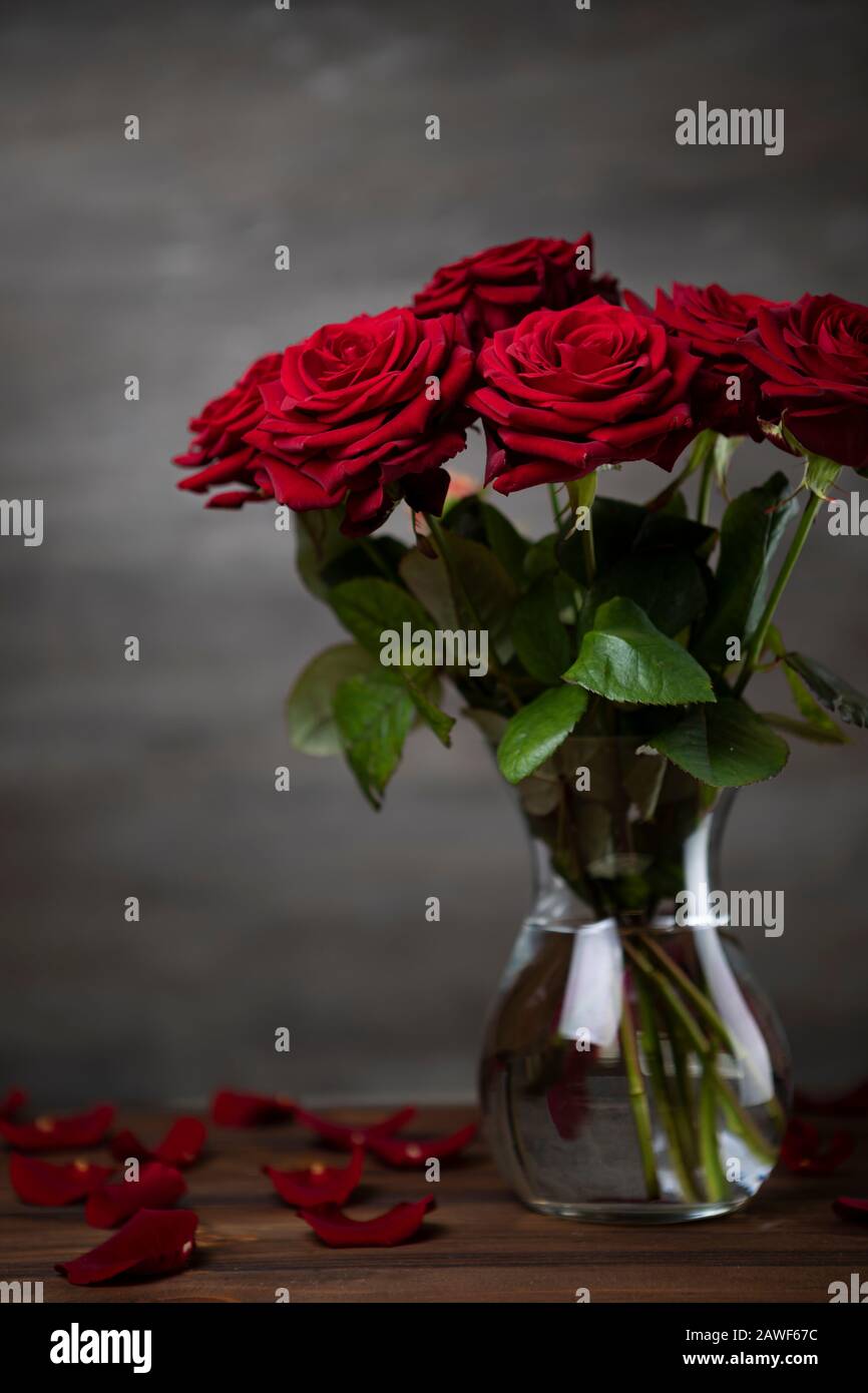 Red roses bunch on the moody background Stock Photo - Alamy
