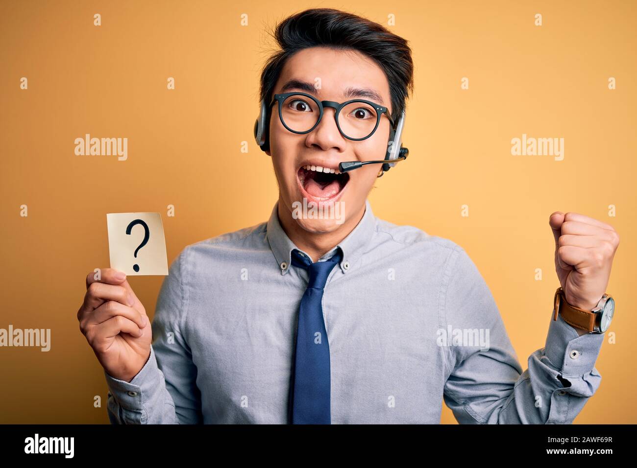 Young handsome chinese call center agent man holding paper with ...