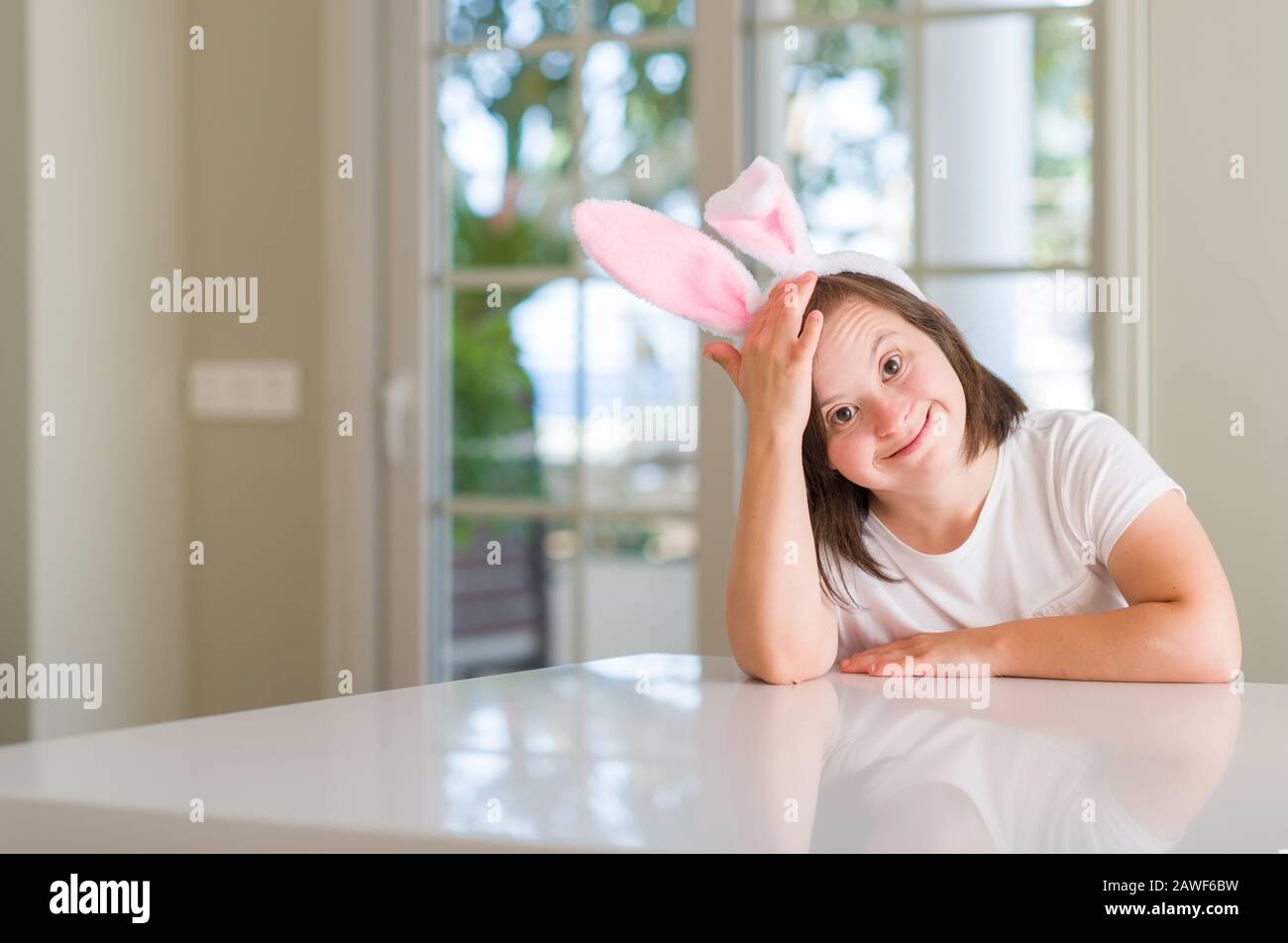 Down syndrome woman at home wearing easter rabbit ears stressed with ...
