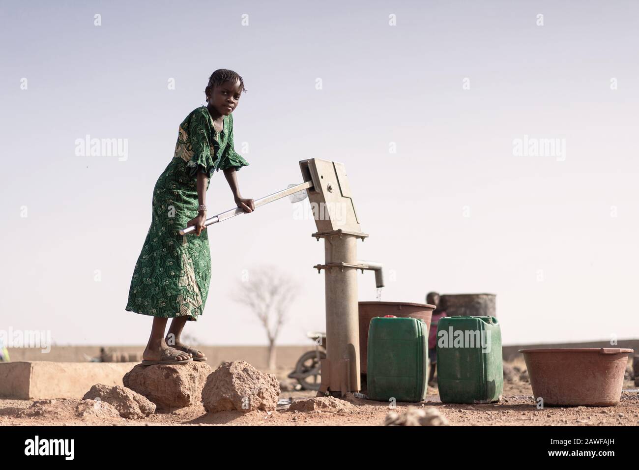 Beautiful African ethnic Young Girl Transporting Fresh Water for a ...