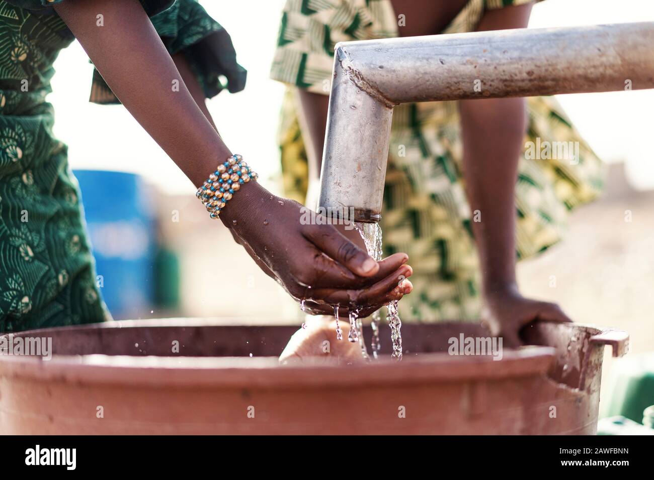 Tiny Native African Woman getting Pure Water for lack of water symbol ...