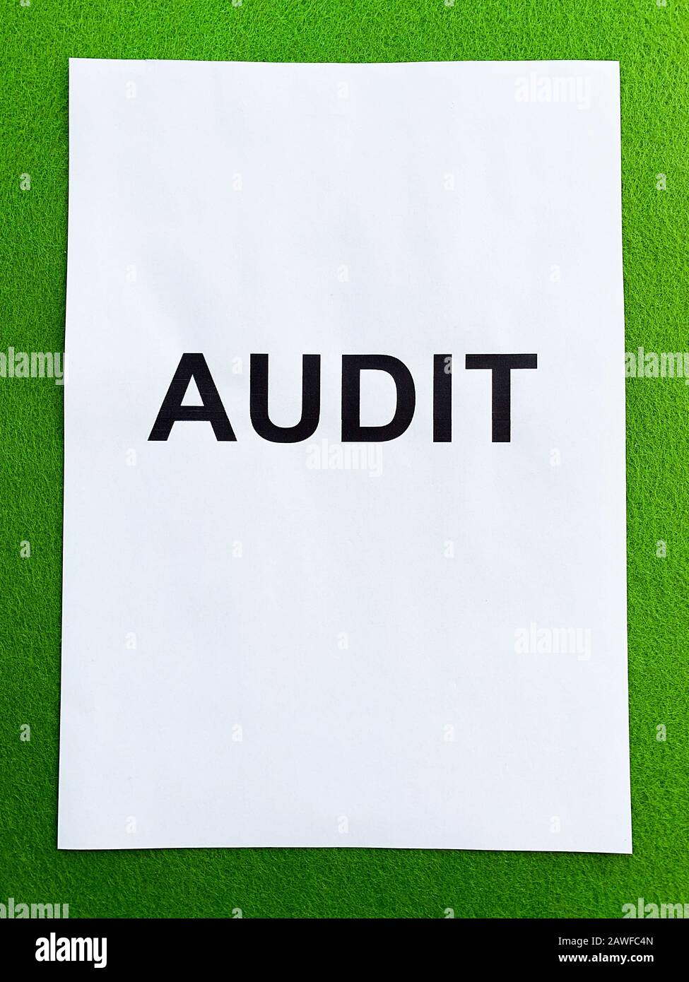 Document with title audit on green background, top view Stock Photo - Alamy