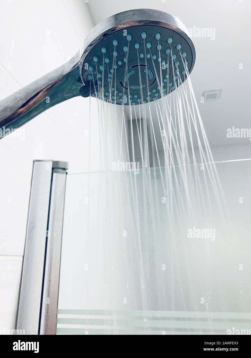 Close up of water flowing from shower in bathroom Stock Photo - Alamy