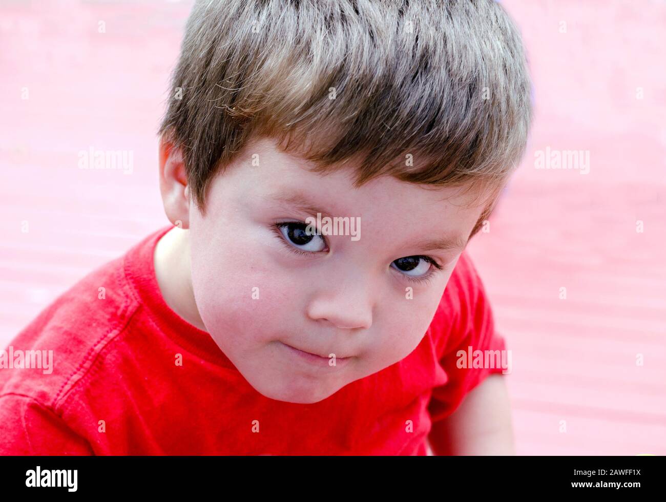 Portrait of a young boy looking up with a curious expression Stock ...