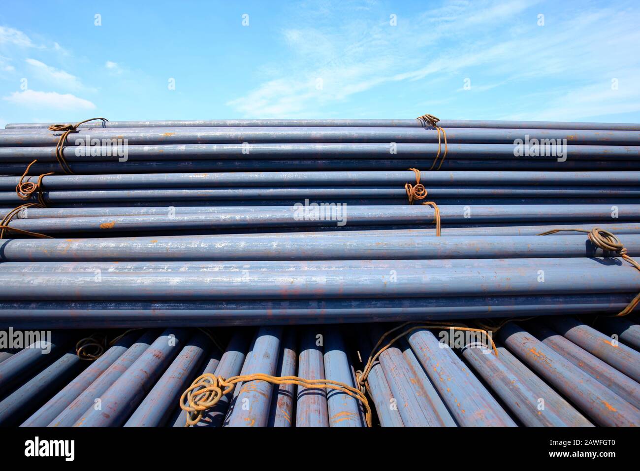 Stack of round steel bar Stock Photo - Alamy