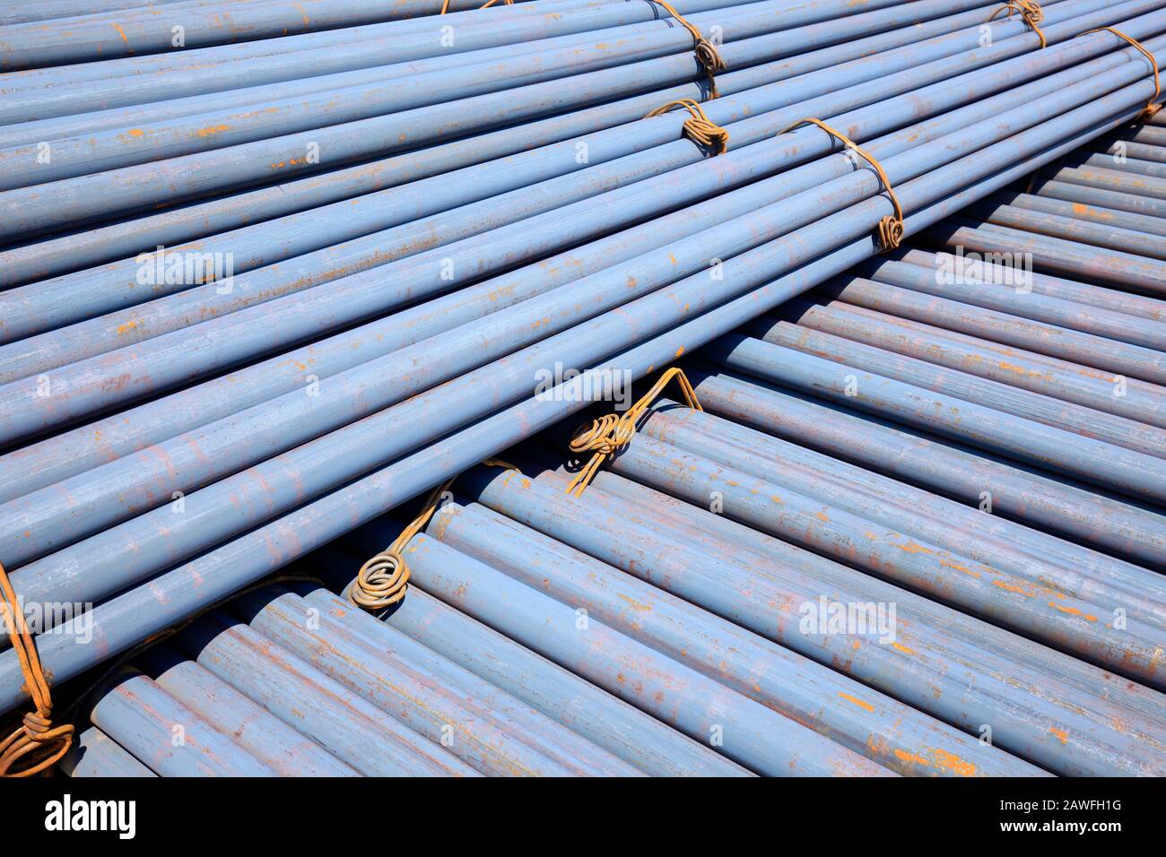 Stack of round steel bar Stock Photo - Alamy