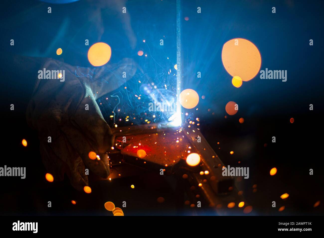 Metal processing in the workshop. Grinding metal. The worker makes the ...