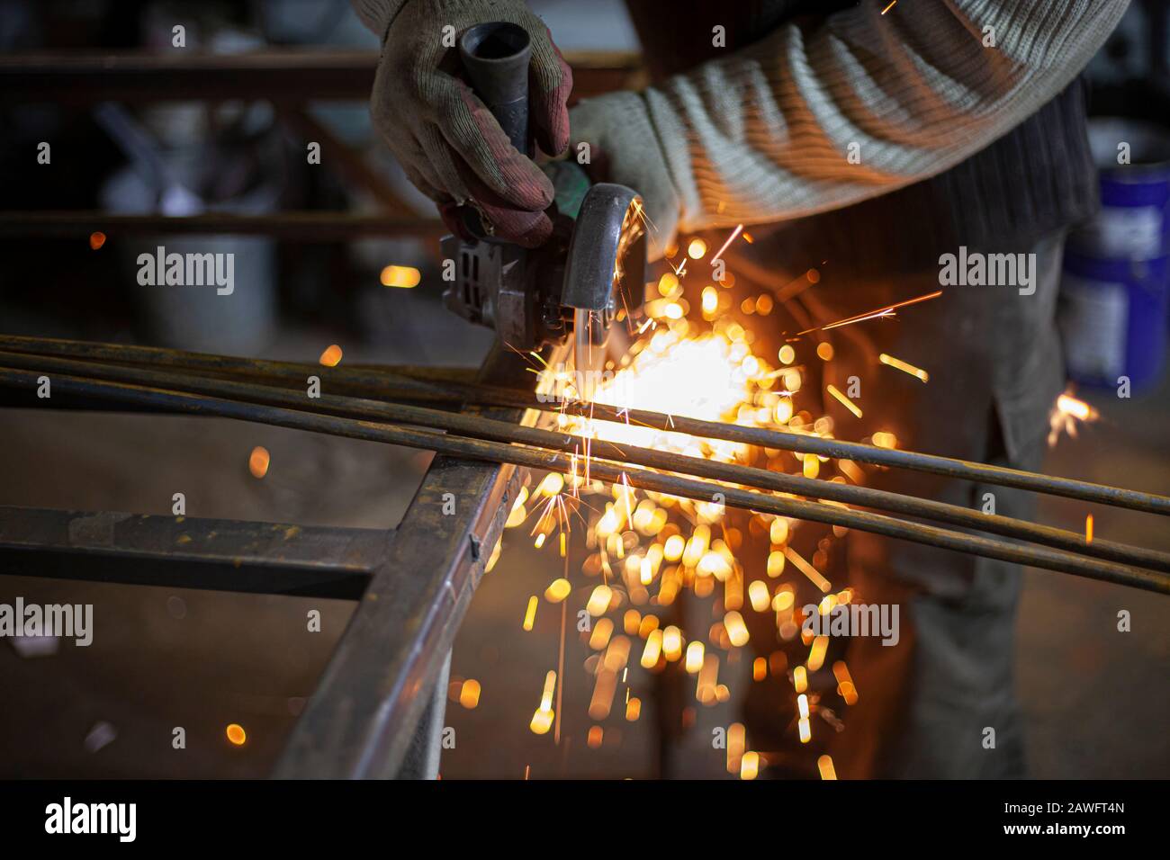 Metal processing in the workshop. Grinding metal. The worker makes the ...