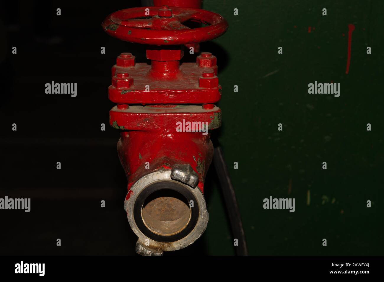 Red valve installed at fire hydrant pipe. old industrial faucet Stock ...