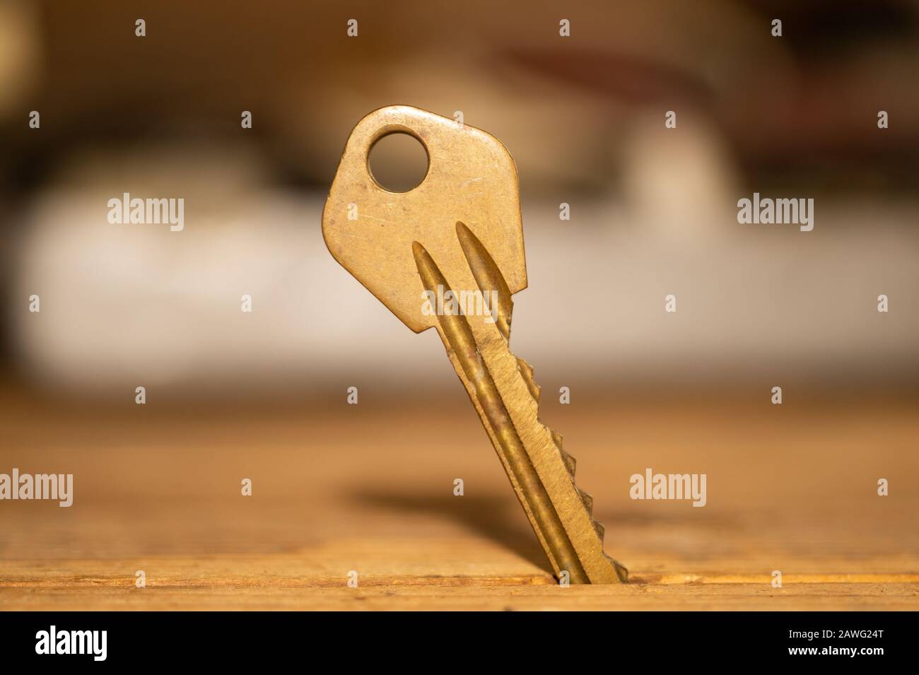 Key stuck in the table. key on wooden background. safety and security ...