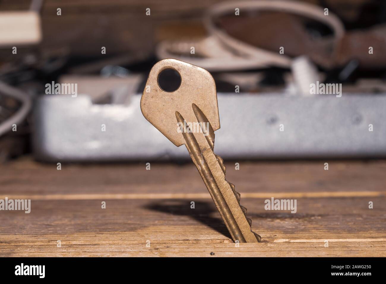Key stuck in the table. key on wooden background. safety and security ...