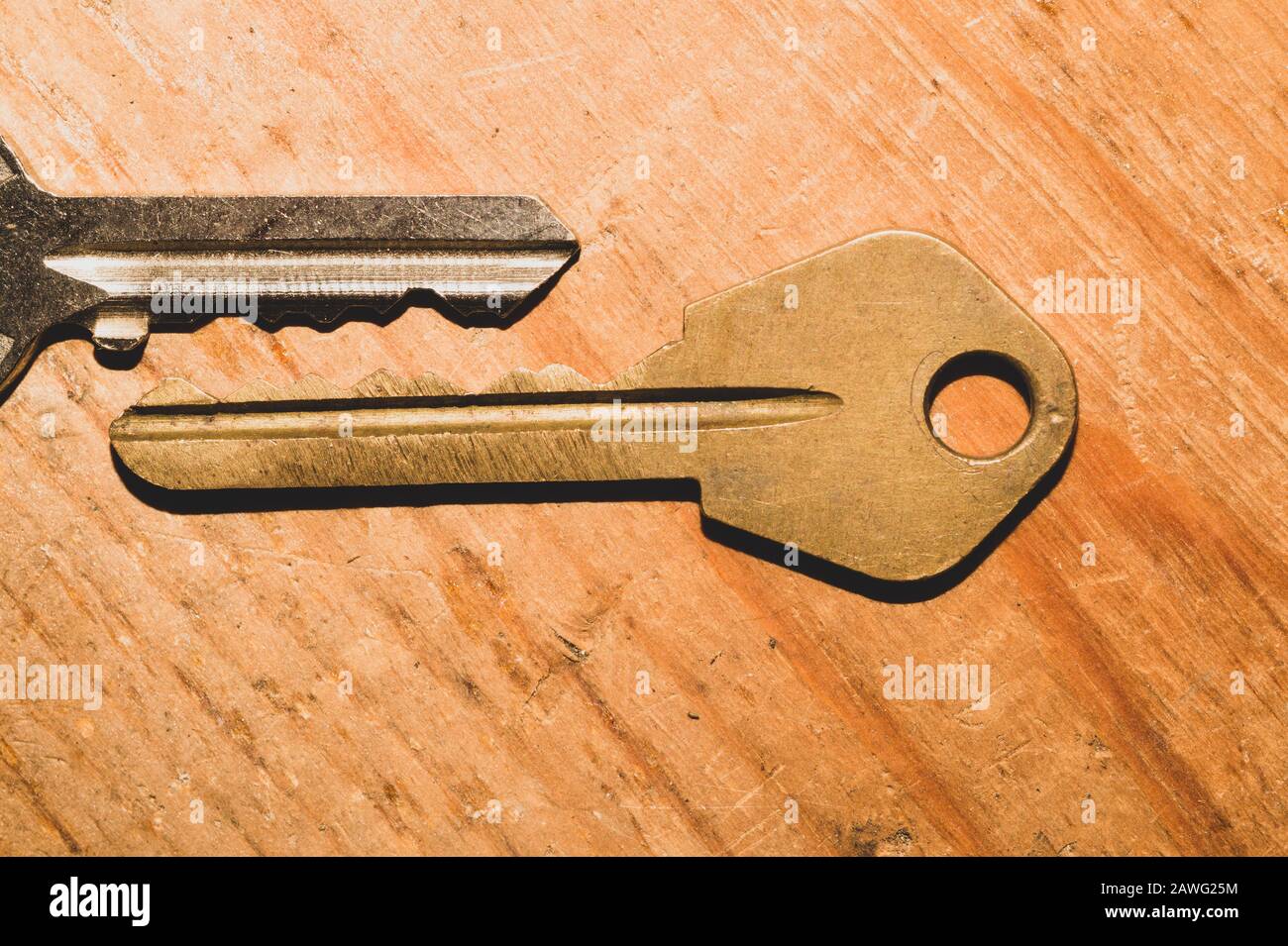Pair of keys isolated on wooden background. safety and security concept ...