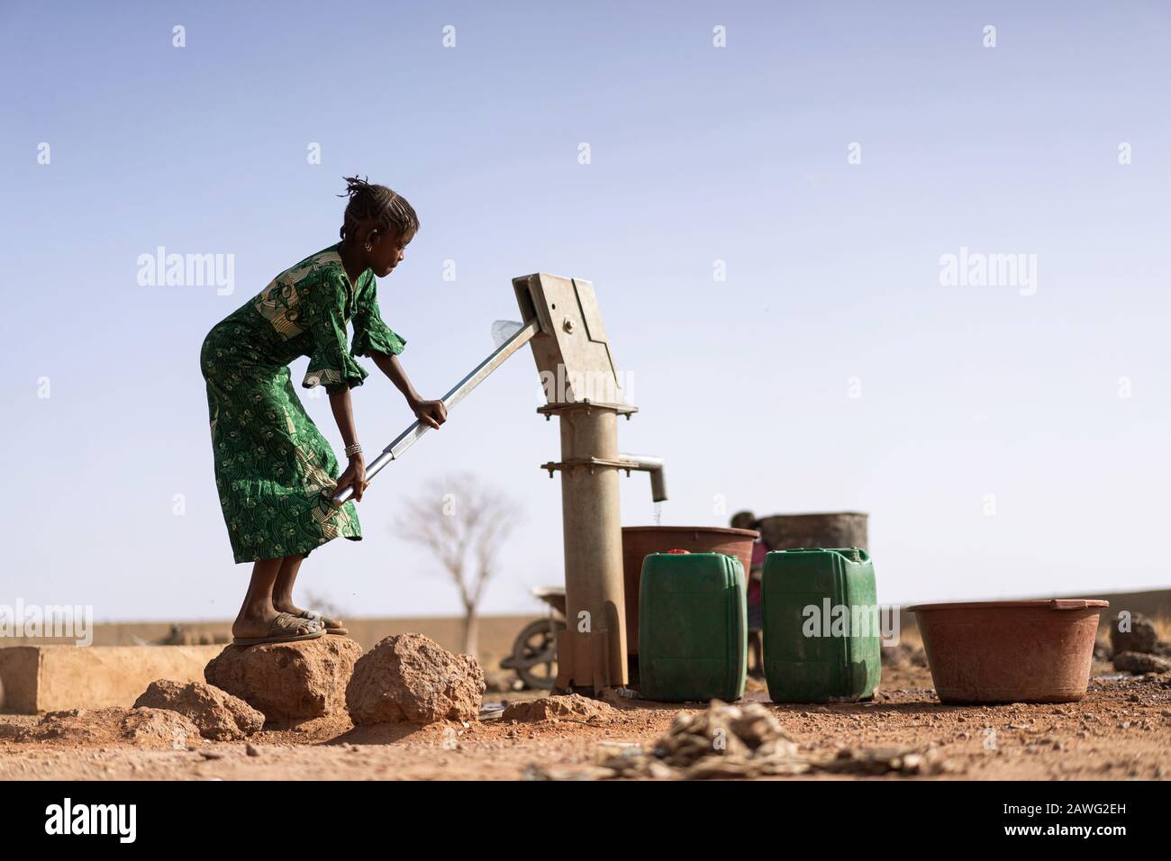 Cheerful African ethnic Girl Bringing Crisp Water in a village Stock ...