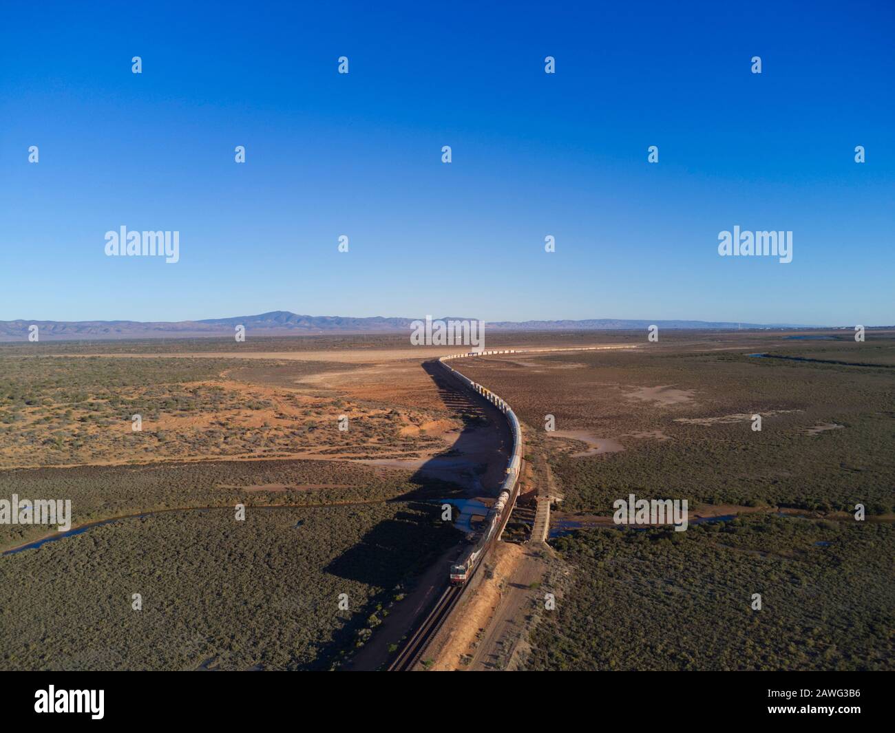 Aerial of intermodal double decker container freight train leaving Port ...