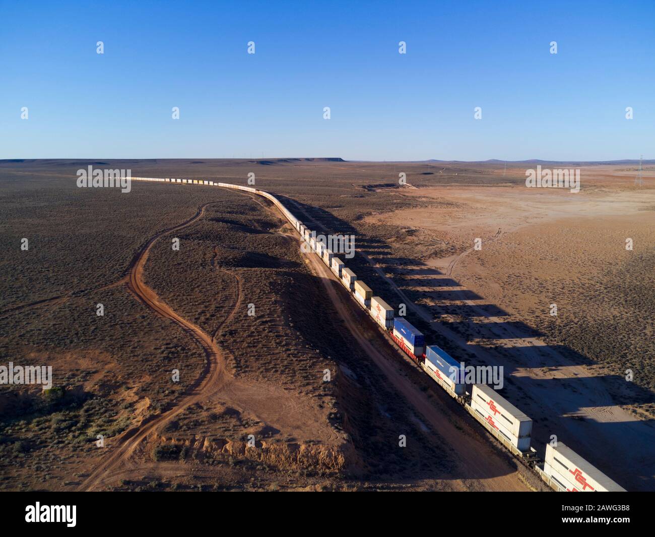 Aerial of intermodal double decker container freight train leaving Port ...