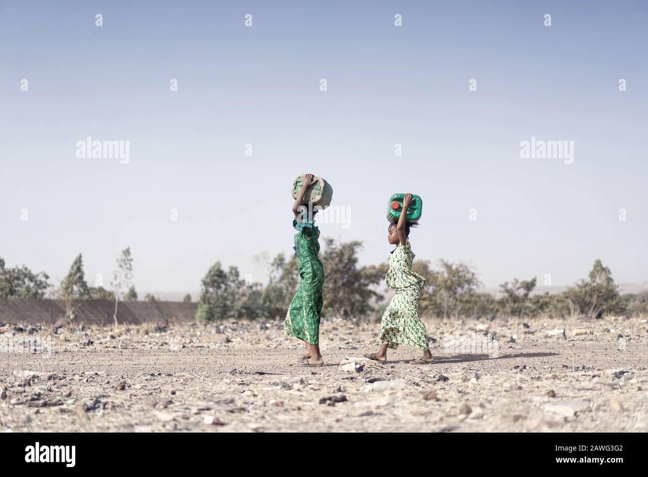Cheerful African Ethnicity Infant Carrying Healthy Water for a ...