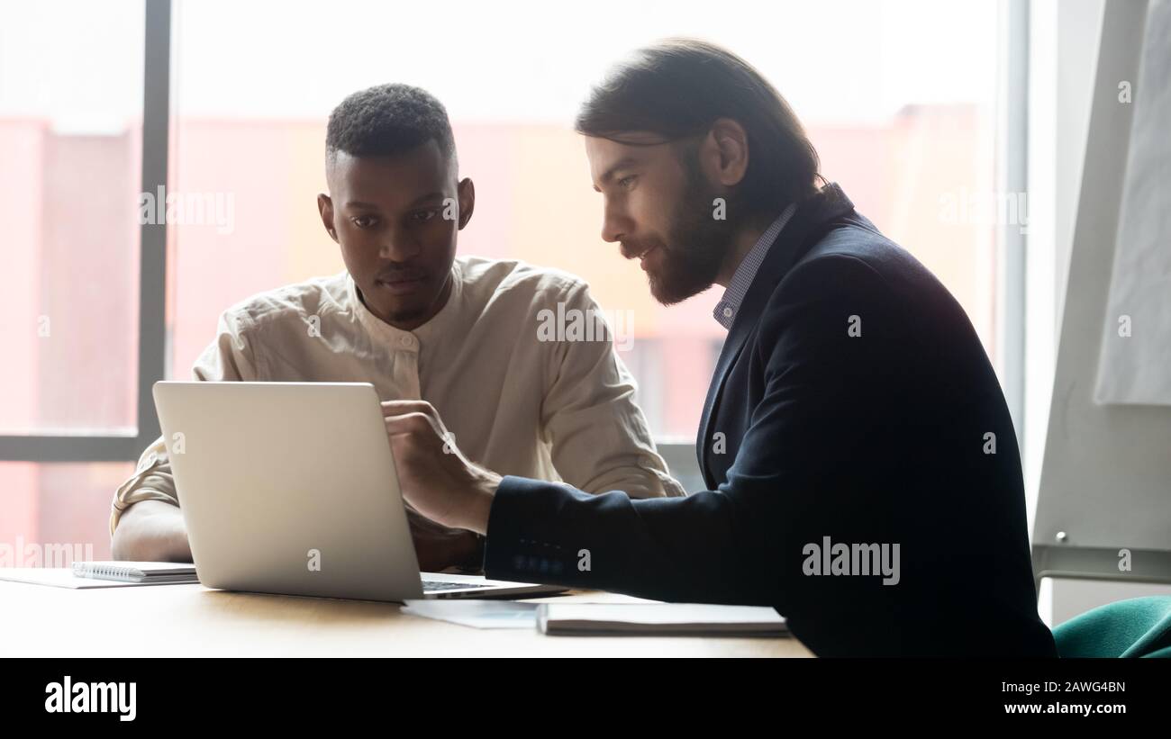 Mentor Coach Pointing At Screen Training African American Young Intern