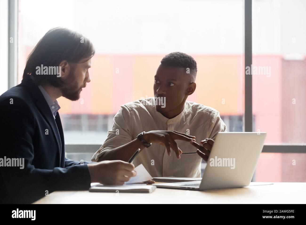 African American manager consulting client about insurance at meeting ...