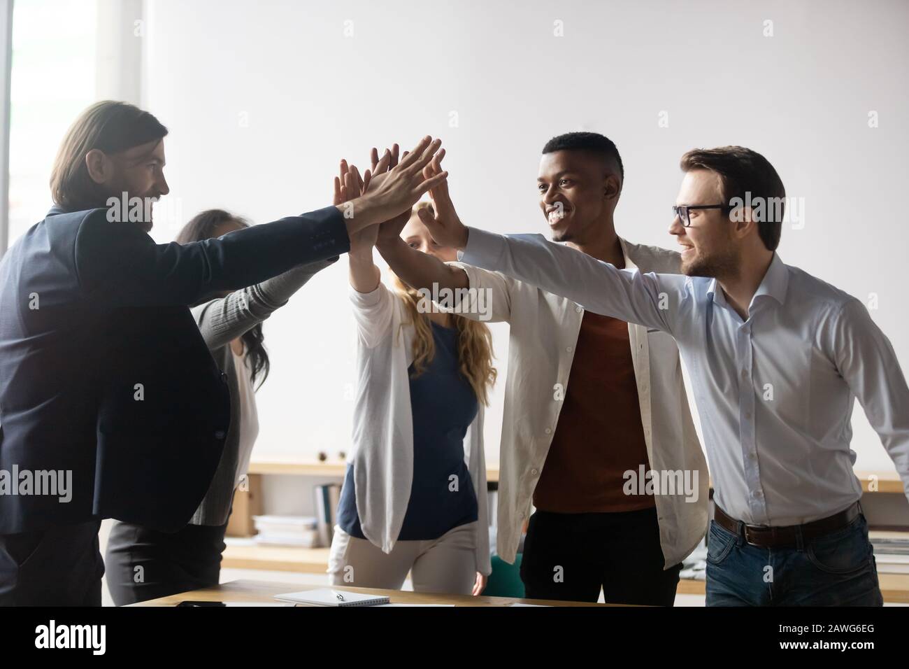 Excited successful diverse business people giving high five ...