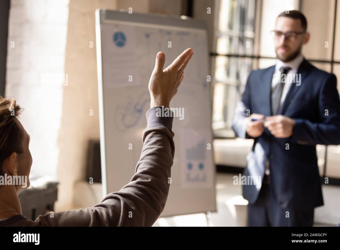 Workshop participant raise hand ask question closeup focus on arm Stock ...