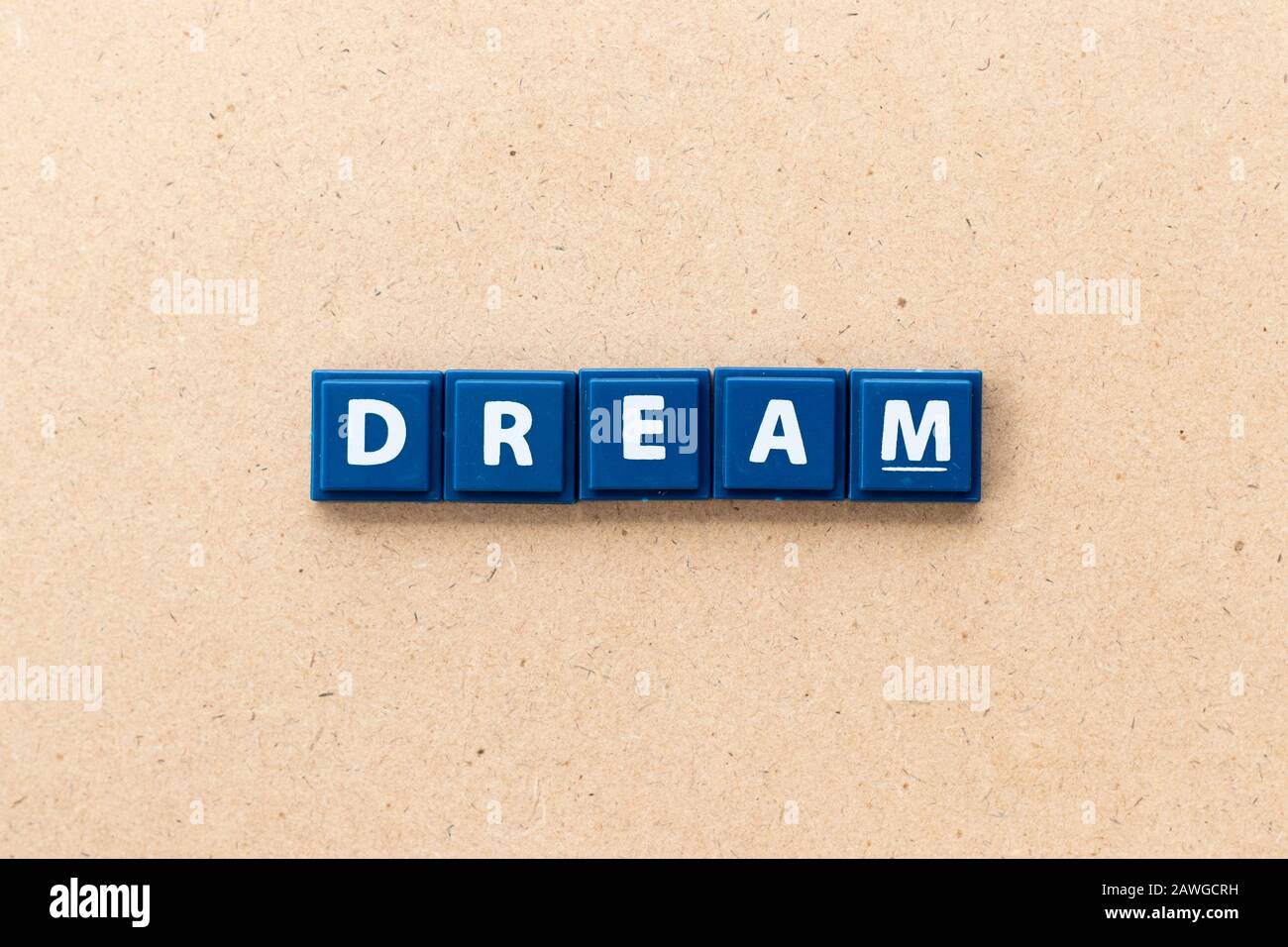 Tile letter in word dream on wood background Stock Photo - Alamy