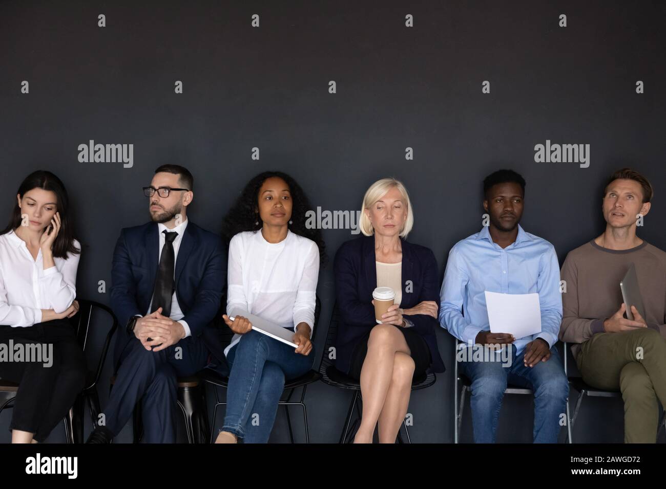 Multicultural applicants waiting turn for job interview seated on ...