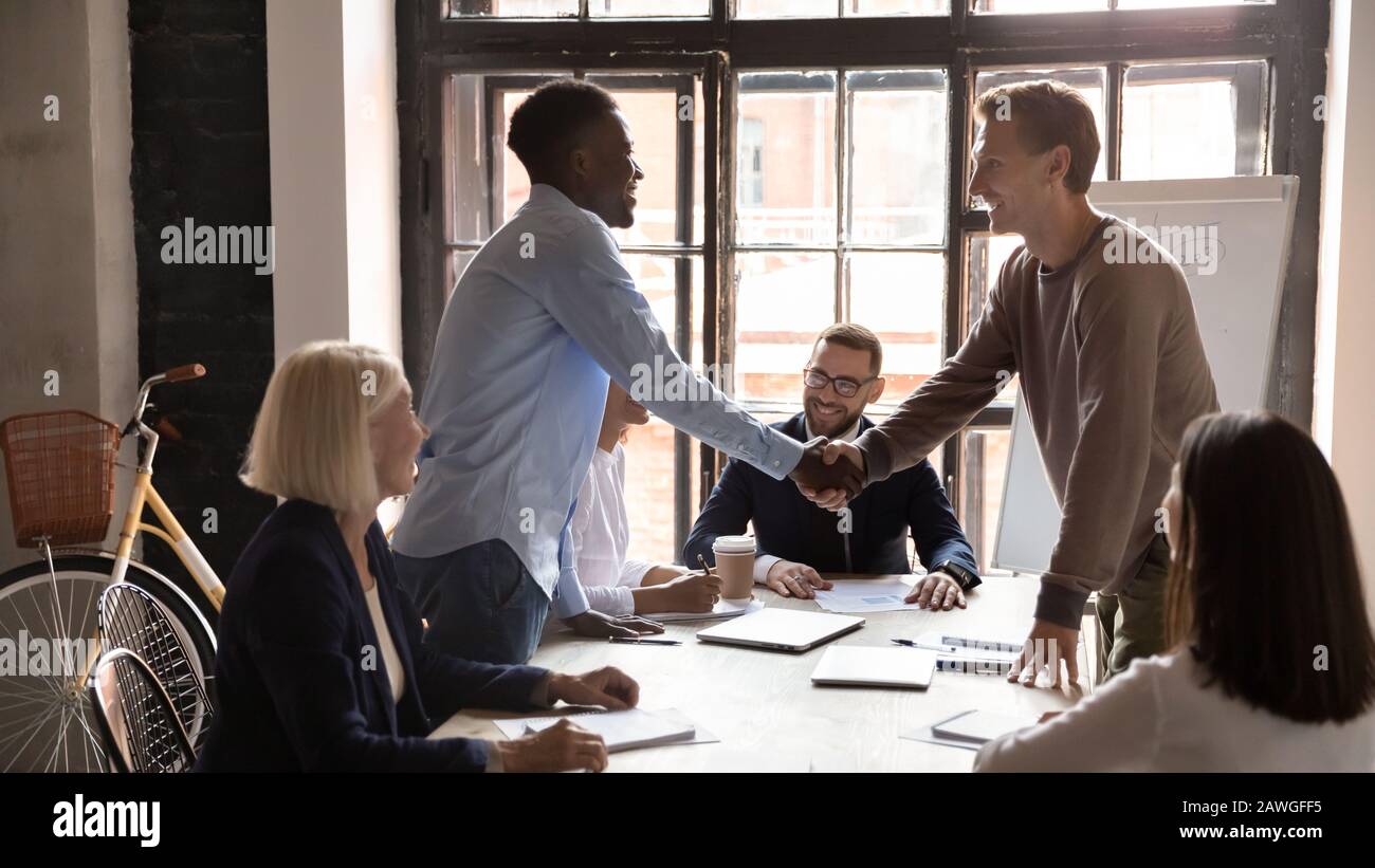 African businessman company executive manager handshaking with european ...