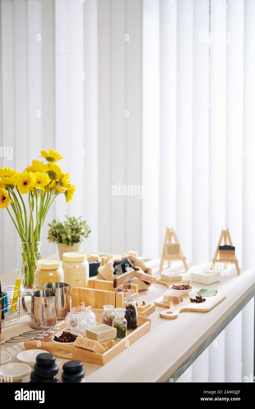 Workshop table with handmade soap bars and dry herbs and other ...