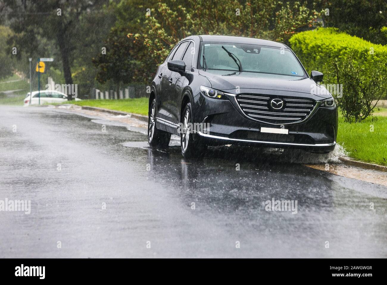 Water masses run down a road during heavy rainfall in Seaford, Sydney ...
