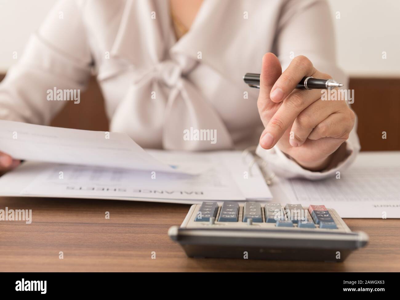 Closeup accountant women check the numbers on the balance sheet ...