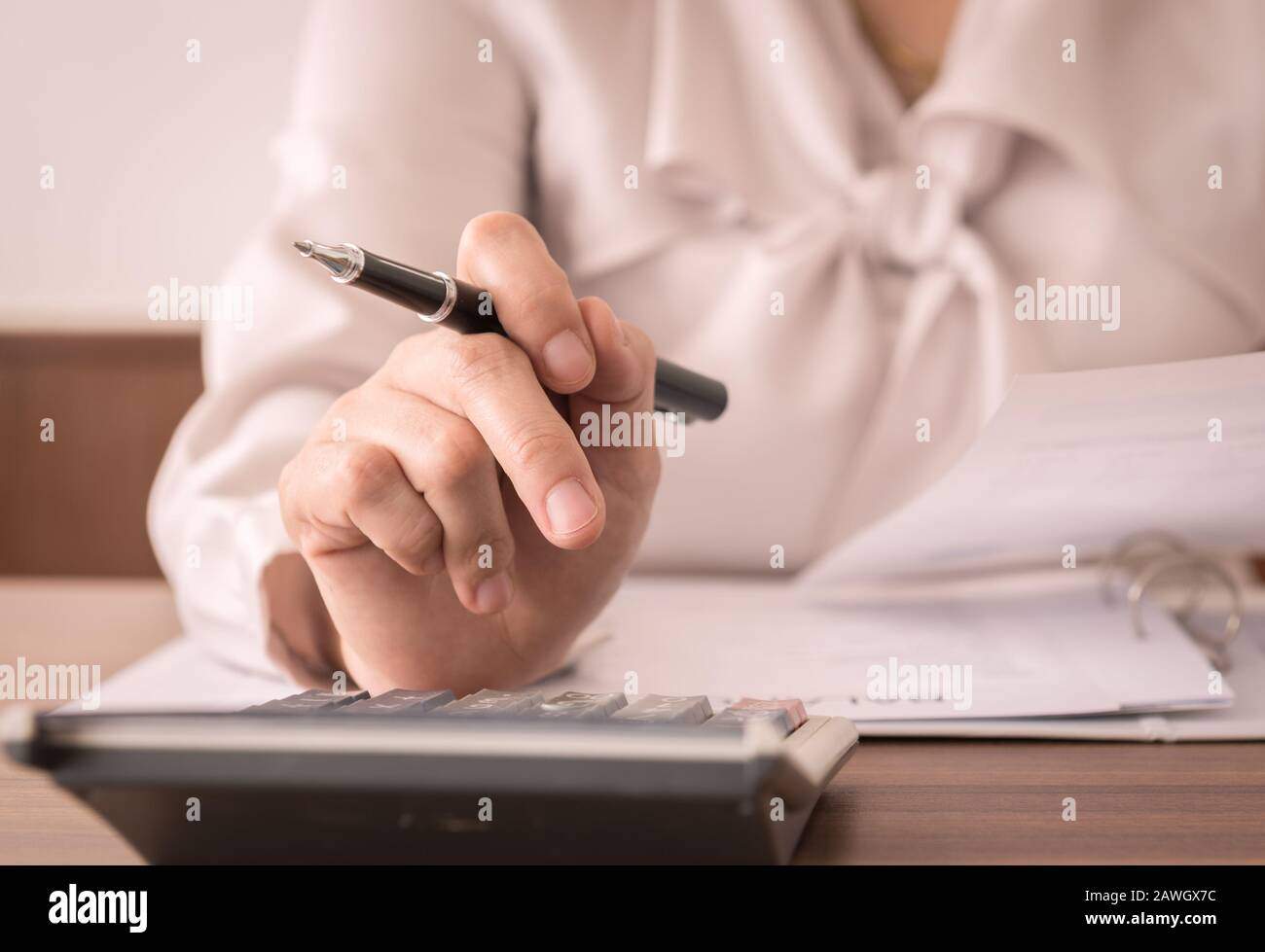 Closeup accountant women check the numbers on the balance sheet ...