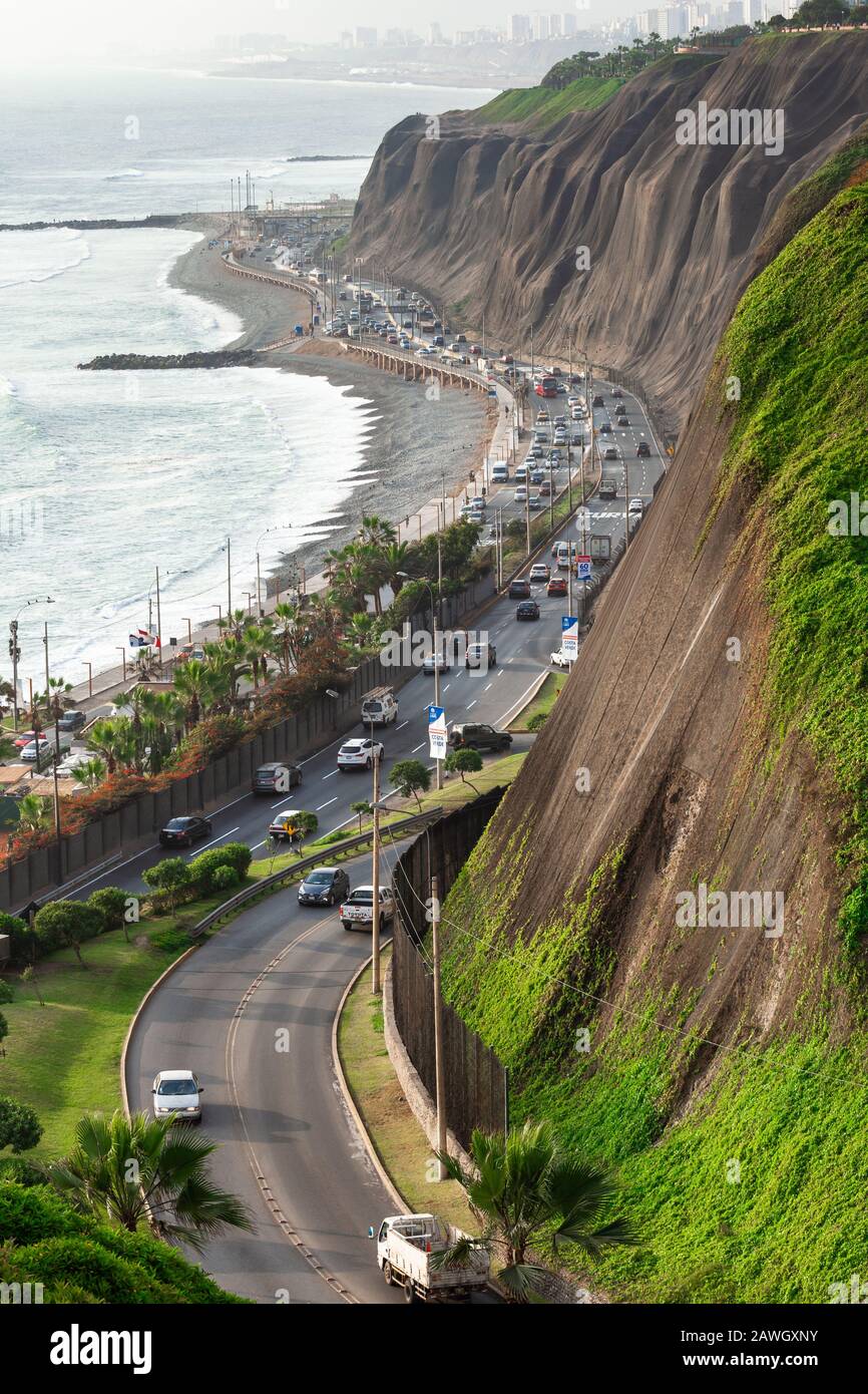 2019-12-07 Lima, Peru. Highway view, traffic, green slope, vertical ...