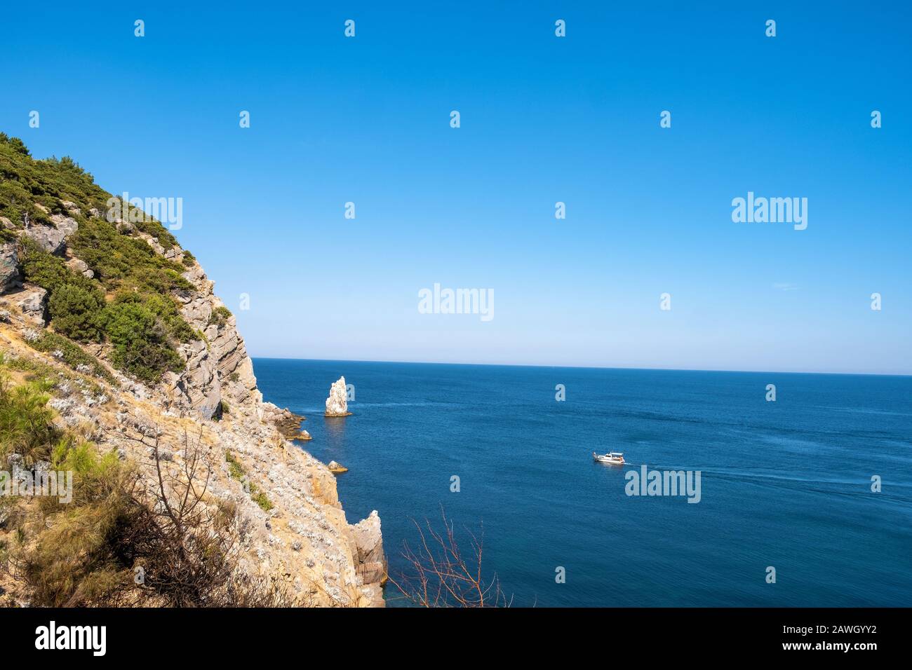 High steep rocky coast on the southern coast of Crimea on a sunny ...