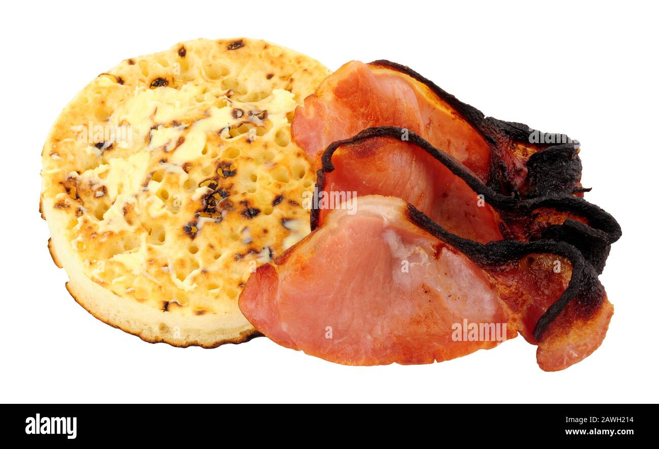 Smoked back bacon rashers on a large English crumpet isolated on a ...