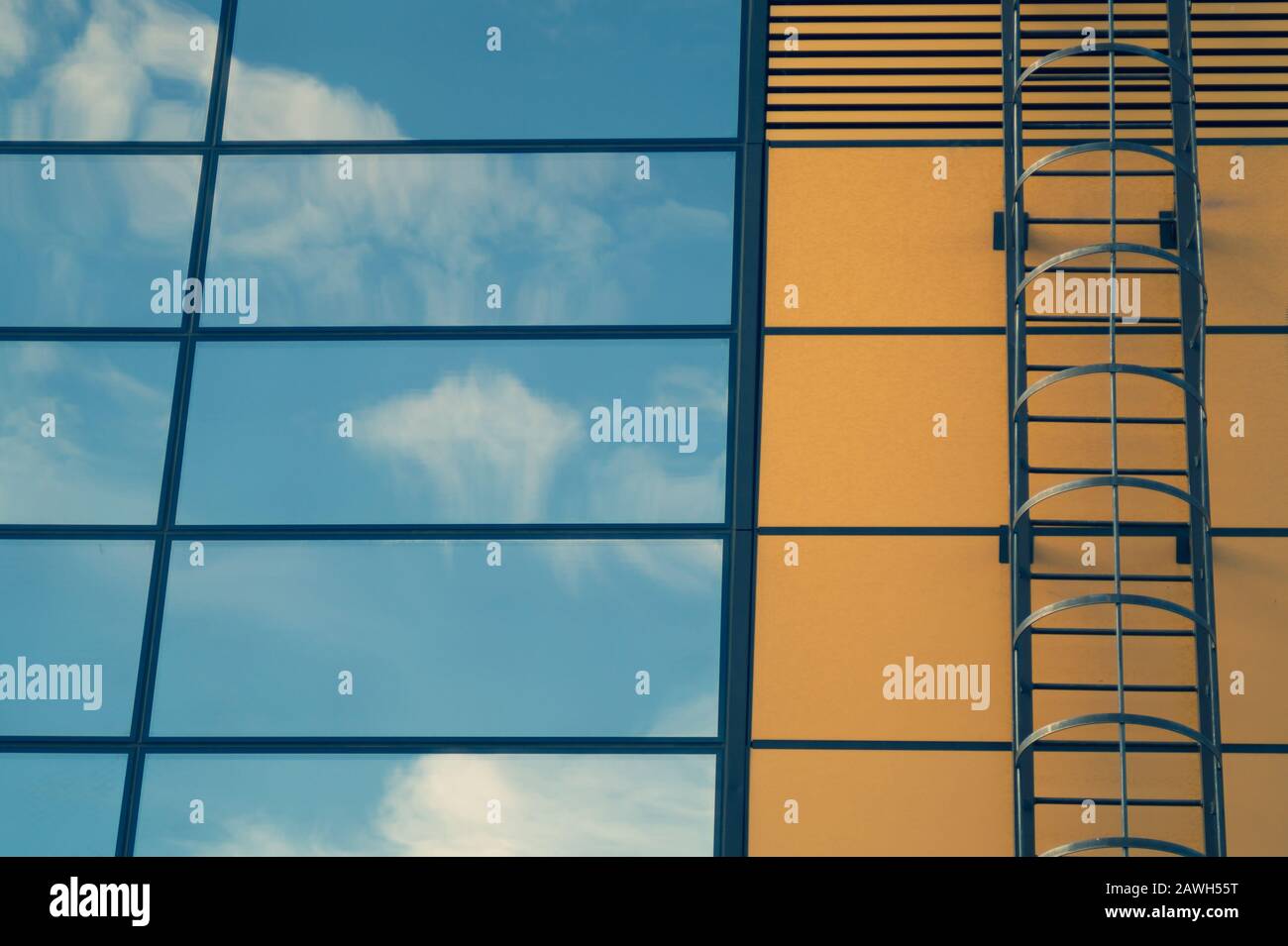 Glass wall of business center with sky reflection. modern building with ...